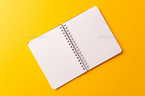 Top view of an open journal isolated on a yellow background Stock Photo ...
