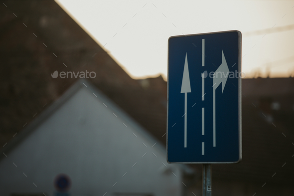 Closeup shot of a traffic sign with two arrows in different directions ...