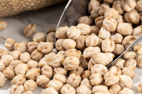 Close up of Chickpeas on scoop on White marble Background Stock Photo ...