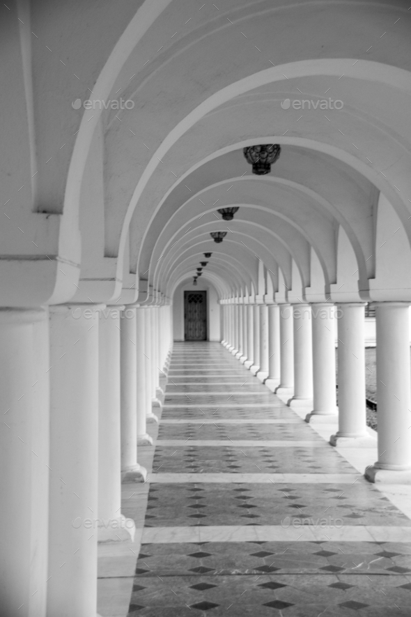 Vertical shot of a corridor with many columns Stock Photo by wirestock