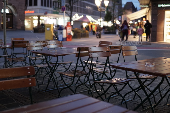 Close up shot of the wooden tables and chairs in the outside area of a ...