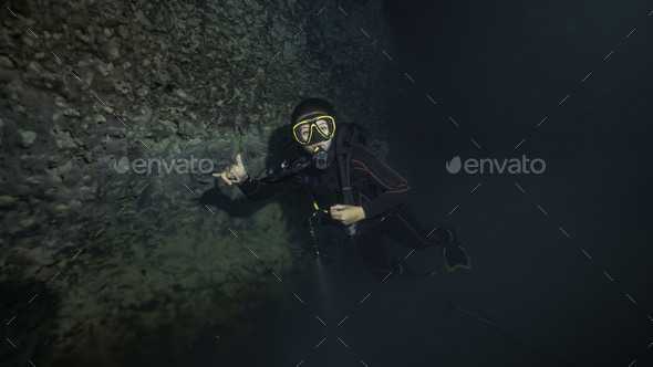 female scuba diver diving in a cave cenote in mexico Stock Photo by ...