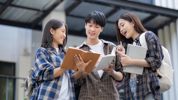 Group of young Asian college students sitting on in front of the school ...