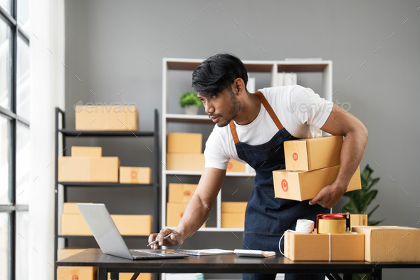 Male online store small business owner entrepreneur seller packing ...