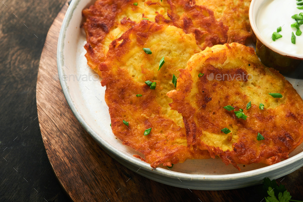 Potato pancakes. Fried homemade potato pancakes or latkes with cream ...