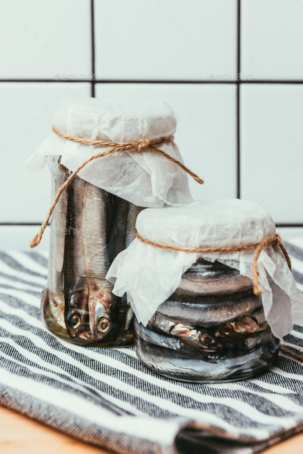 Pile of salted fish in jars wrapped by strings on towel Stock Photo by ...