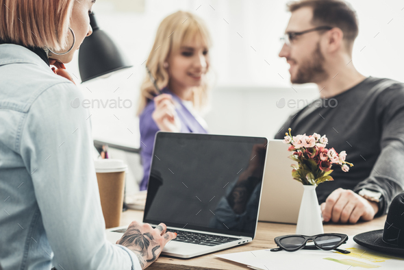 selective focus of young creative workers working on new idea in office ...