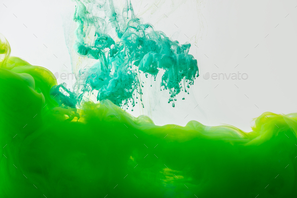 close up view of mixing of green and bright turquoise paints splashes ...