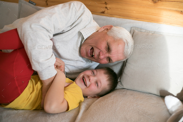 Granddad and cute boy with funny face. Elderly old relative with child ...