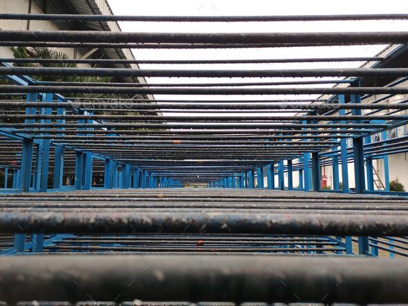 Surface of many industrial steel lines and sticks between blue metal ...