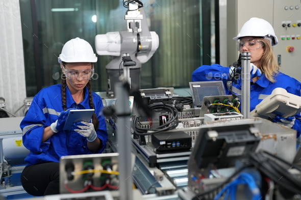 Robotic Arm engineer check on equipment in its with software of an ...
