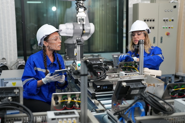 Robotic Arm engineer check on equipment in its with software of an ...