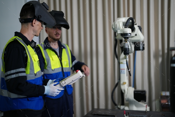 Robotic Arm engineer check on equipment in its with software of an ...