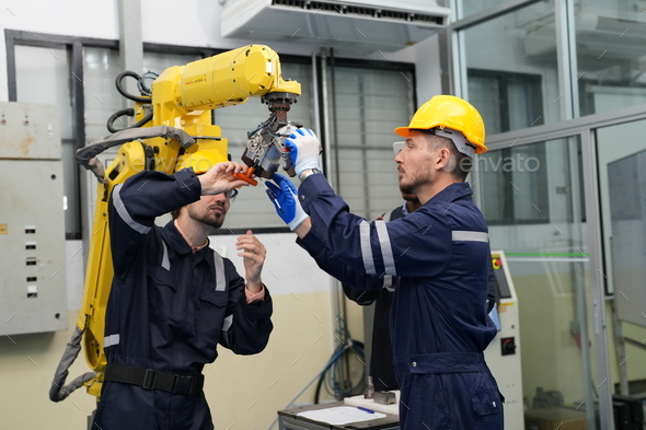 Robotic Arm engineer check on equipment in its with software of an ...