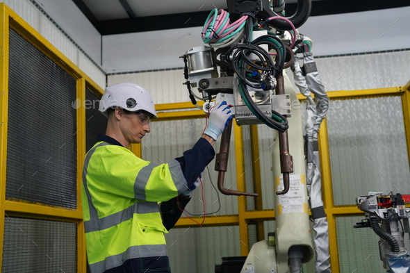 Robotic Arm engineer check on equipment in its with software of an ...
