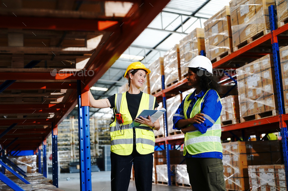 Warehouse workers working in the large logistic distribution warehouse ...