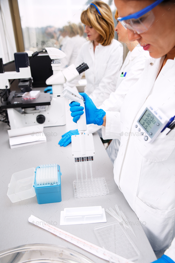 Photo of three real female scientists researching in laboratory. Stock ...
