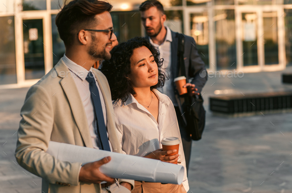 Group of business people walking outside in front of office buildings ...