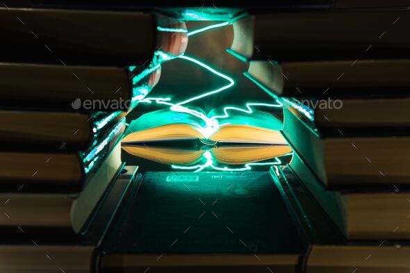 Open book in the library and lightning coming out of the book Stock ...