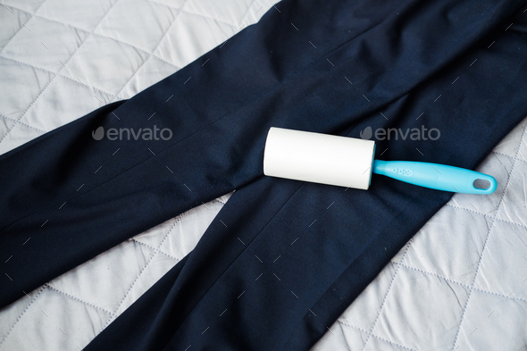 roller for cleaning clothes from dust and pellets on dark trousers, top ...