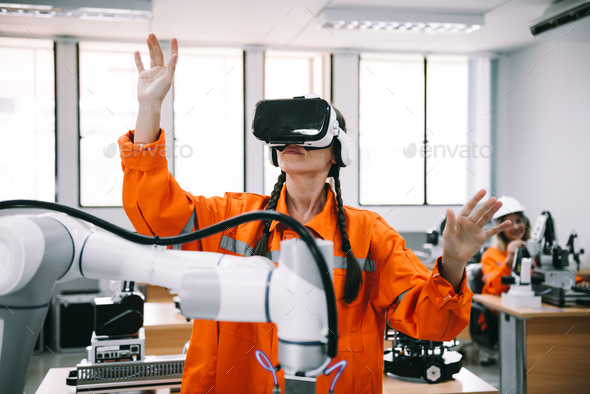 Engineering female wearing VR glasses for simulate control automation robotic welding machines ...