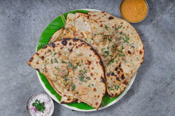 Top view of veg stuffed paratha with gravy and curd raita Stock Photo ...