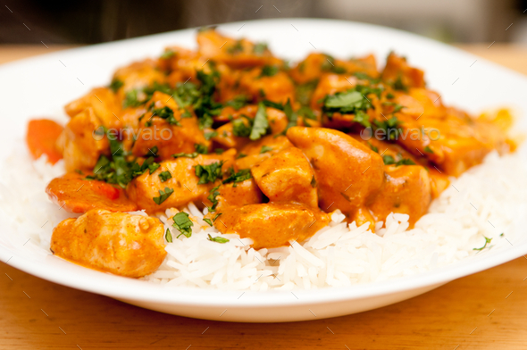 Chicken korma, rice, and creamy sauce topped with chopped cilantro ...