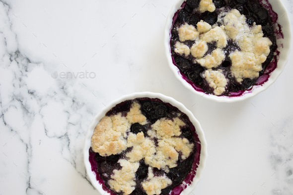 Top view of delicious cherry crumbles in bowls on the table under the ...