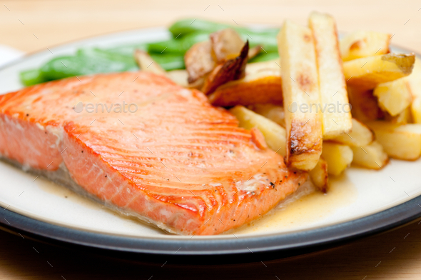 maple glazed salmon fillet with french fries and snap peas, full Stock ...