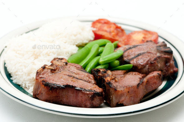 lamb chops with tomato, rice and snap peas Stock Photo by wirestock