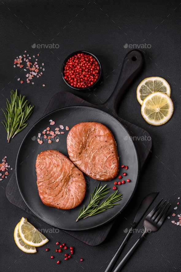 Two baked slices of tuna fillet with spices and herbs Stock Photo by ...