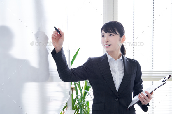 Japanese woman writing on a whiteboard Stock Photo by cait00sith ...