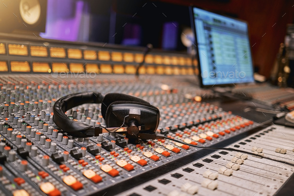 Sound board, music and production with headphones in recording studio ...