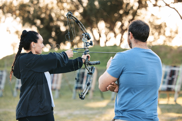 Woman, archery and target training with an instructor on a field for ...