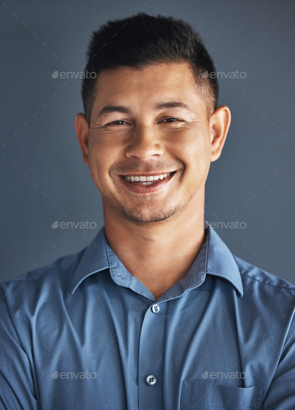 Face portrait, smile and business man in studio isolated on a blue ...