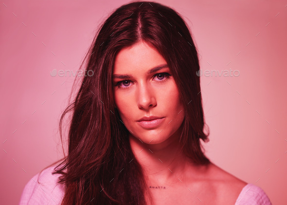 Portrait, neon and gen z with a model woman in studio on a pink ...