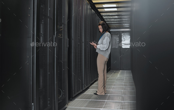 Tablet, server room and data center with a programmer asian woman at ...