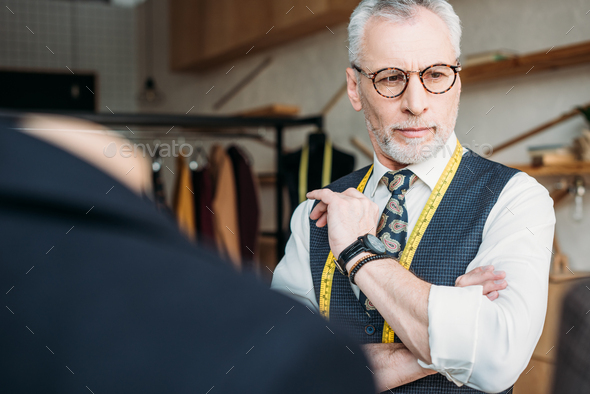 handsome grey hair tailor standing at sewing workshop Stock Photo by ...