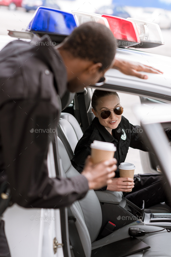 young police officers with car drinking coffee to go Stock Photo by ...