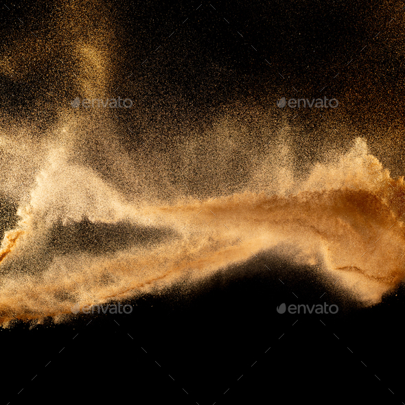 Sand explosion isolated on black background. Freeze motion of sandy ...