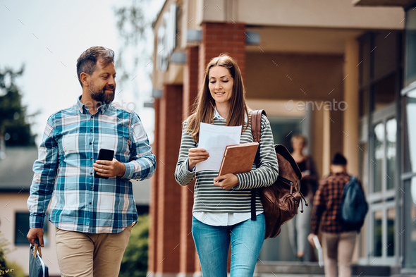 Happy adult students walking through campus after the lecture. Stock ...