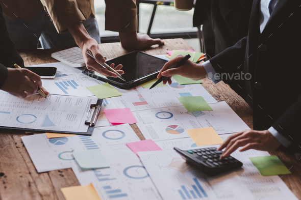 Business People Meeting using chart graph calculator, laptop computer ...