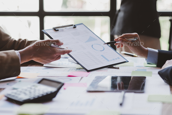 Business People Meeting using chart graph calculator, laptop computer ...