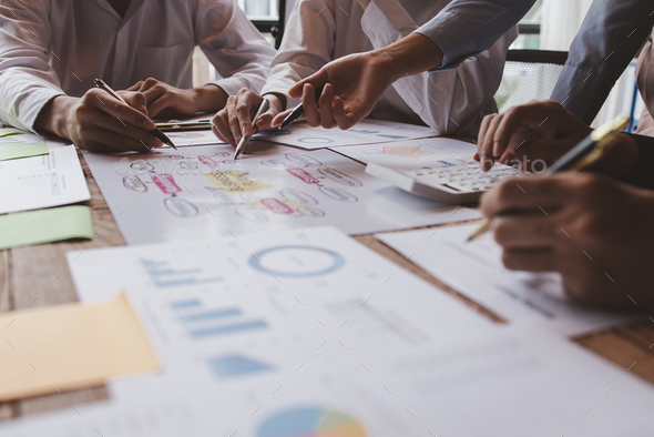 Business People Meeting using chart graph calculator, laptop computer ...