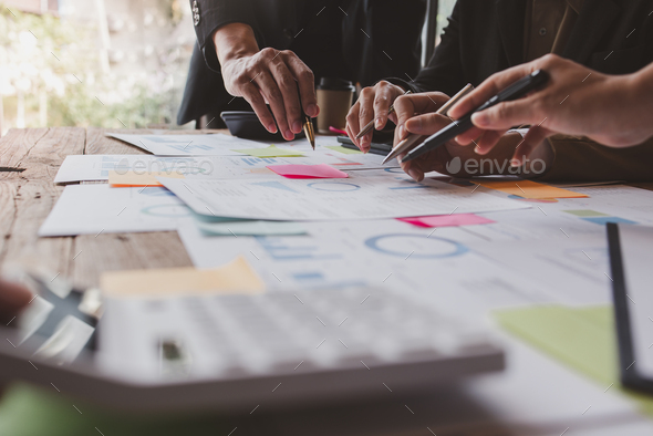 Business People Meeting using chart graph calculator, laptop computer ...