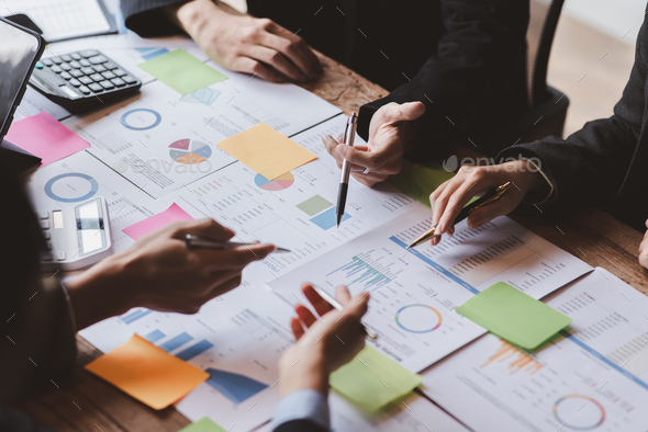 Business People Meeting using chart graph calculator, laptop computer ...