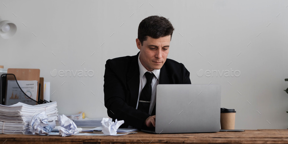 Perplexed, puzzled handsome businessman looking at laptop screen at ...