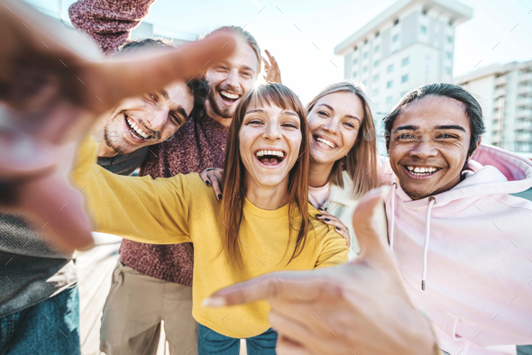 Multicultural group of friends smiling together at camera outside Stock ...