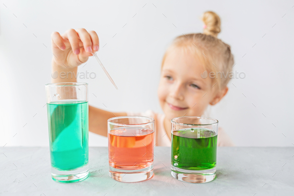 cute little girl six years old doing laboratory experiment with ...