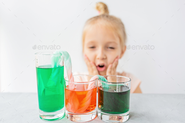 cute little girl six years old doing laboratory experiment with ...